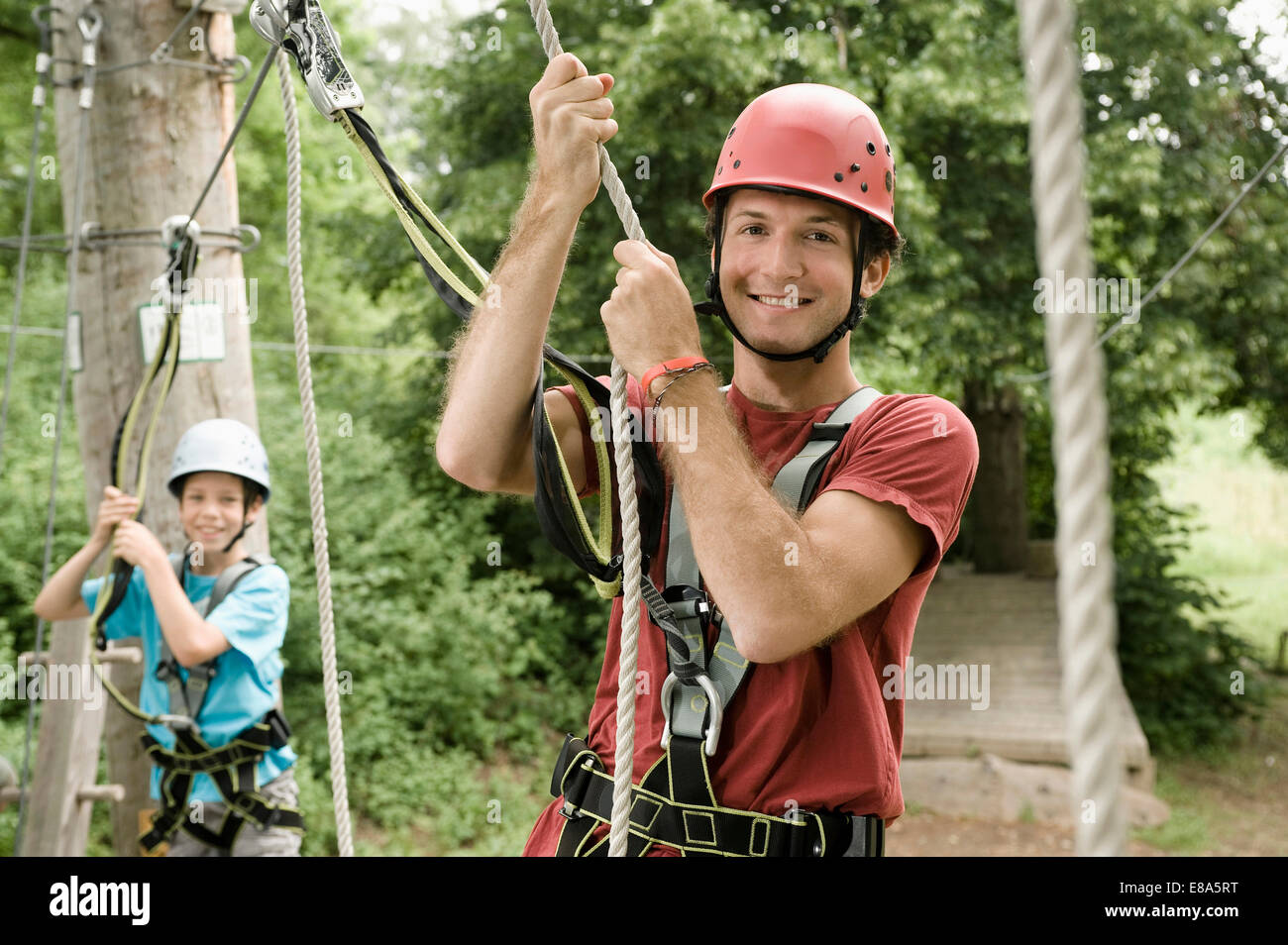 Portrait of young man and boy climbing crag, smiling Stock Photo - Alamy