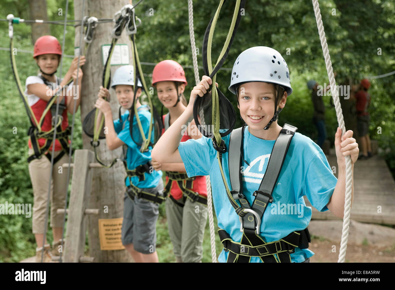 Boys and girls climbing crag, smiling Stock Photo - Alamy