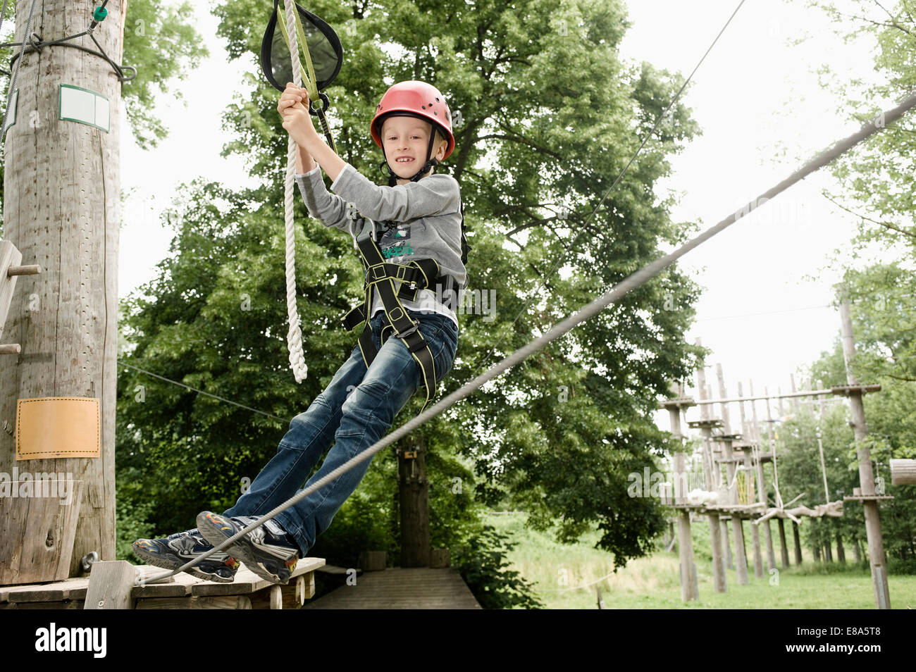 Boy climbing crag, smiling Stock Photo - Alamy