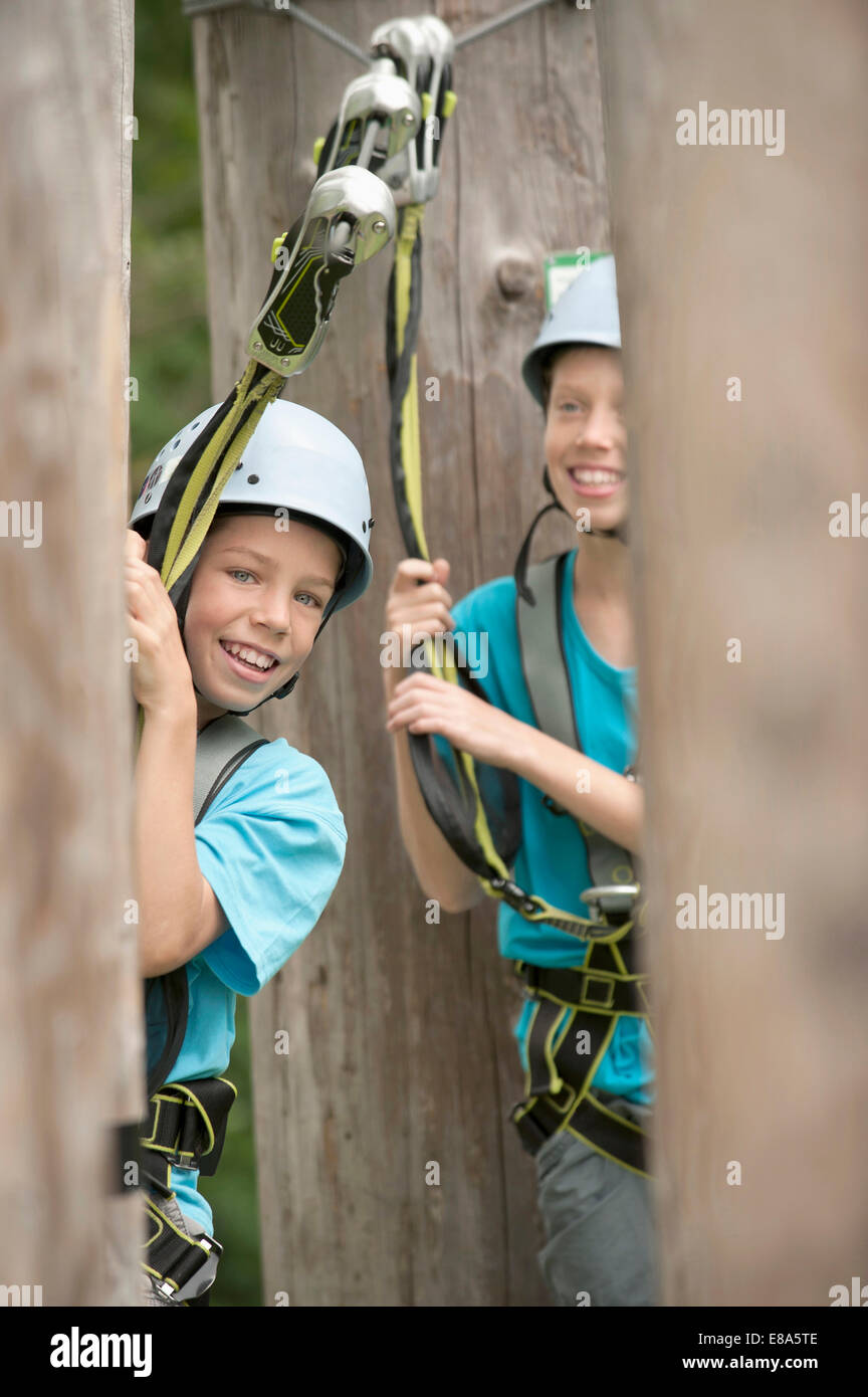 Boys climbing crag, smiling Stock Photo - Alamy