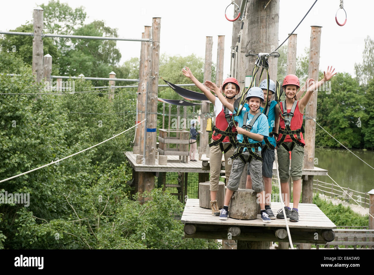 Boys and girls climbing crag, smiling Stock Photo - Alamy
