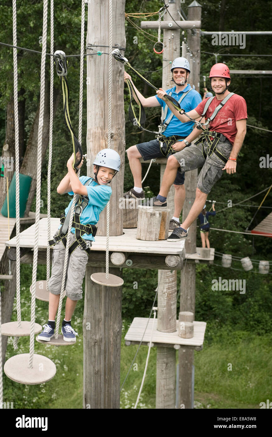 Men and boy climbing crag, smiling Stock Photo - Alamy