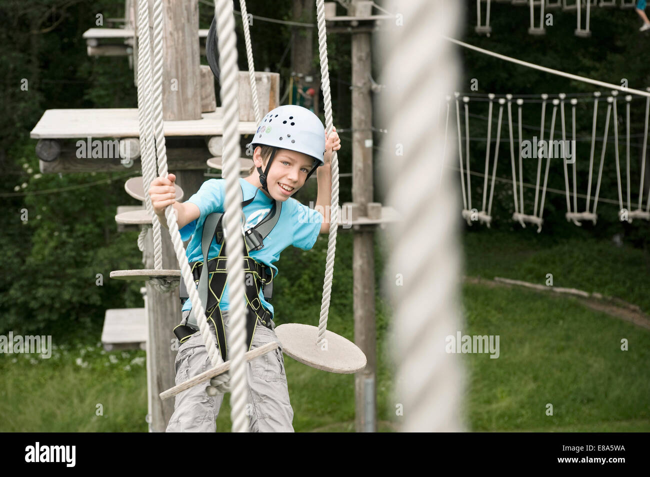 Portrait of boy climbing crag, smiling Stock Photo - Alamy