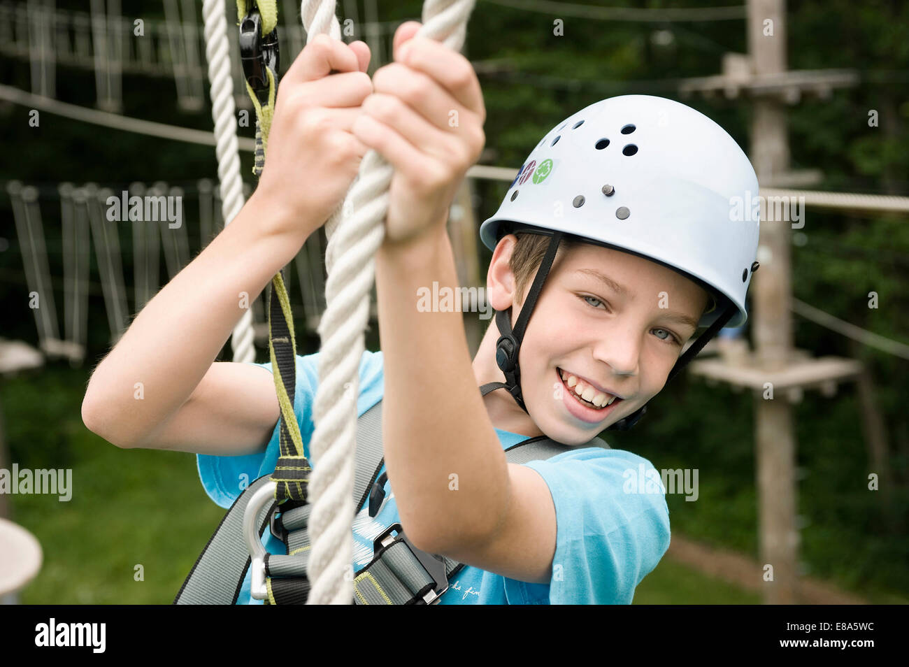 Portrait of boy climbing crag, smiling Stock Photo - Alamy