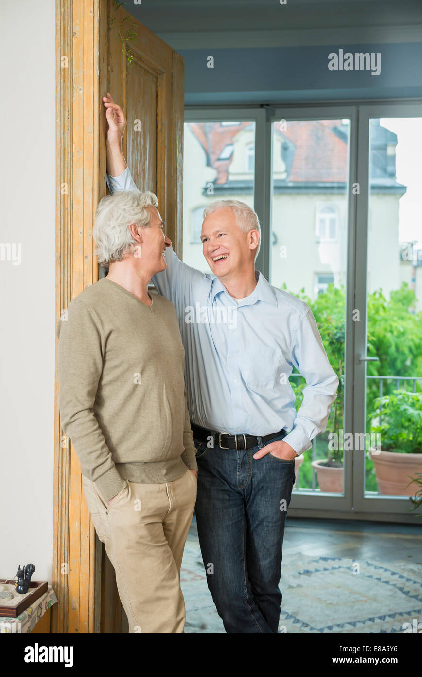 Friends having chat, smiling Stock Photo - Alamy