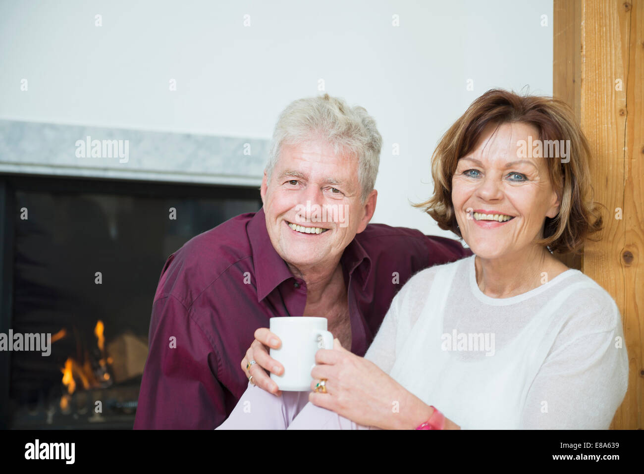 Couple sitting by fireside hi-res stock photography and images - Alamy