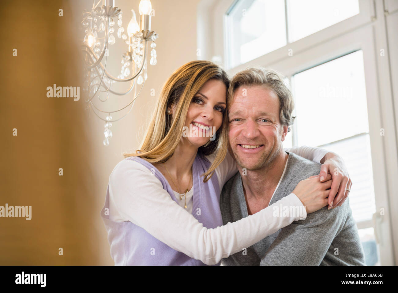 Portrait of happy couple hugging Stock Photo - Alamy