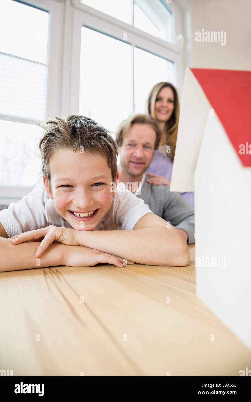 Family with architectural model at table Stock Photo - Alamy