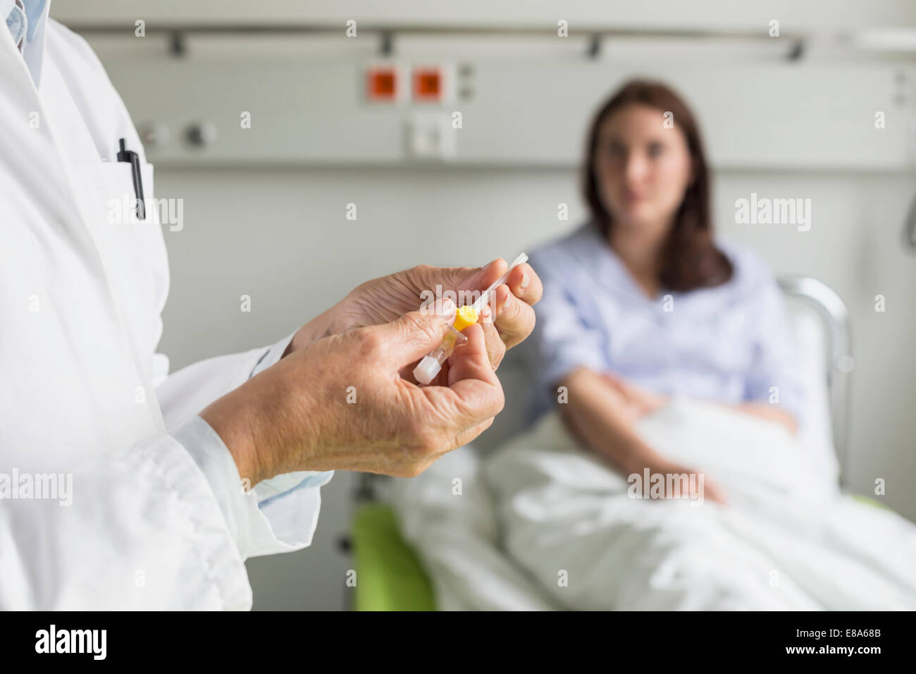 Doctor preparing infusion needle Stock Photo - Alamy