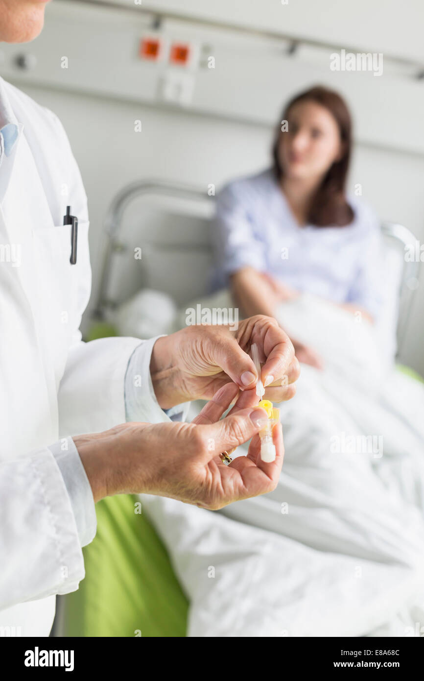 Doctor preparing infusion needle Stock Photo - Alamy