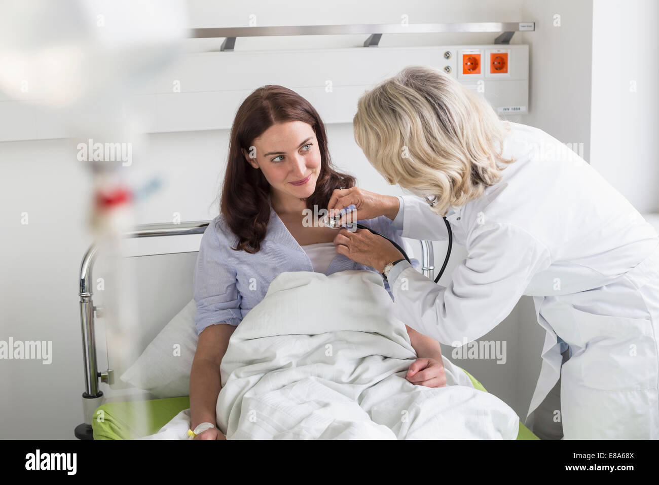 Doctor auscultating patient Stock Photo - Alamy