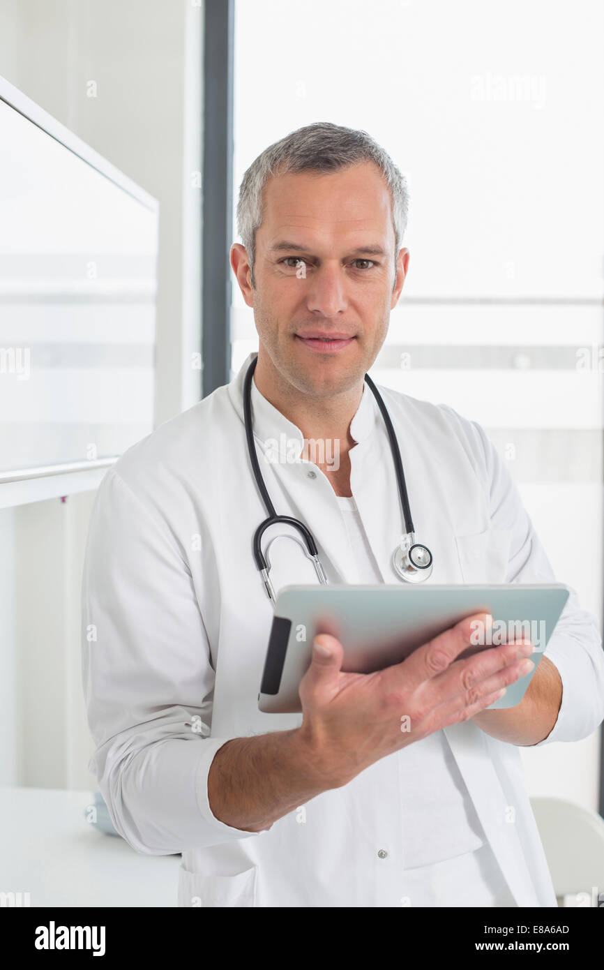 Doctor holding digital tablet, portrait Stock Photo - Alamy