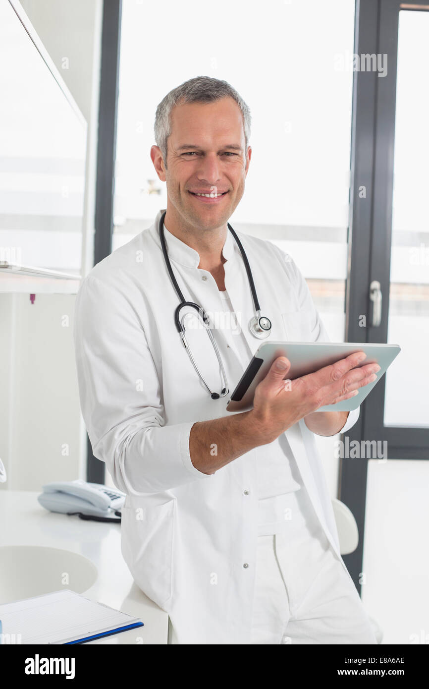 Doctor holding digital tablet, portrait Stock Photo - Alamy
