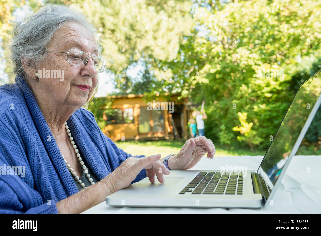 Female senior using laptop Stock Photo - Alamy