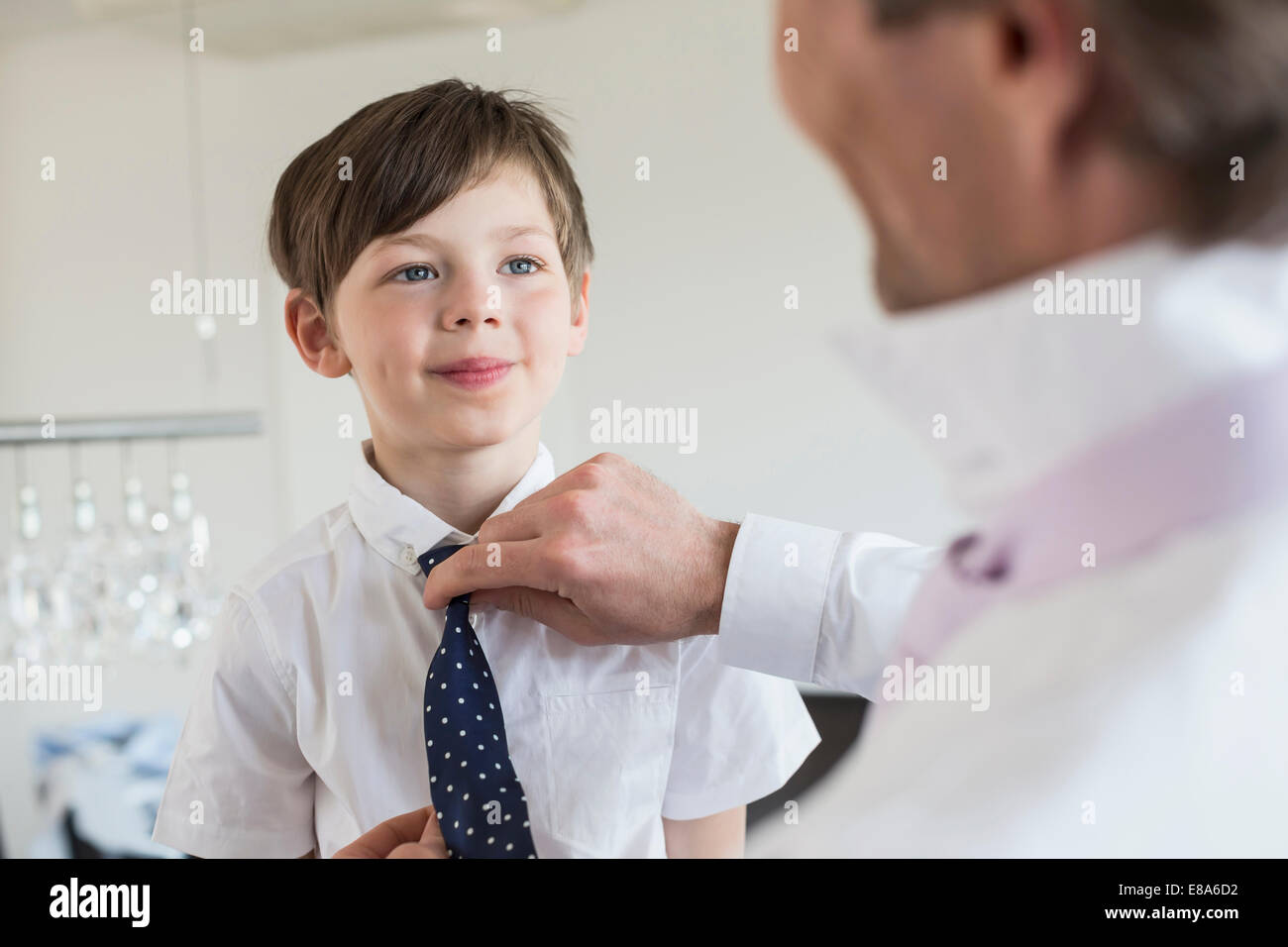 Father adjusting son's tie, smiling Stock Photo - Alamy