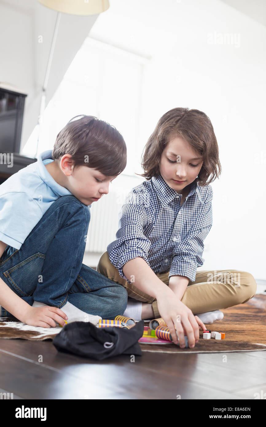 Girl and boy playing board game Stock Photo - Alamy