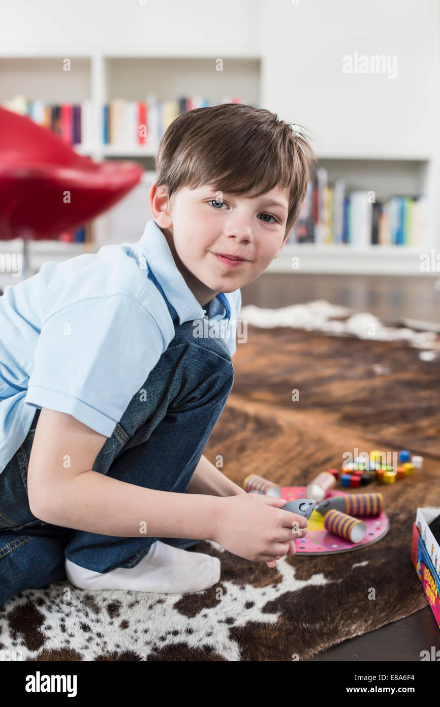 Portrait of boy playing with board game, smiling Stock Photo - Alamy