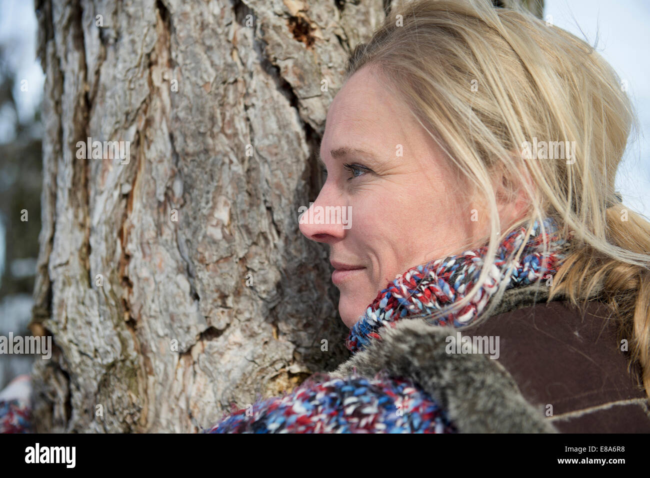 Woman hugging tree trunk, smiling, Bavaria, Germany Stock Photo - Alamy
