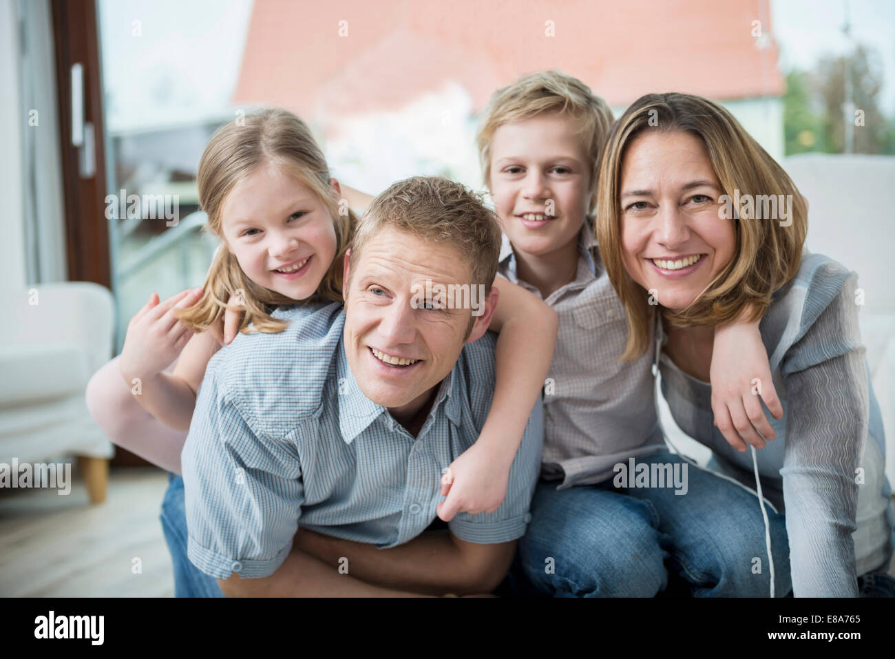 Happy family with two kids at home Stock Photo - Alamy