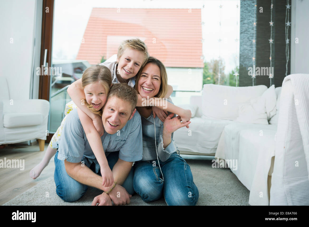 Happy family with two kids at home Stock Photo - Alamy