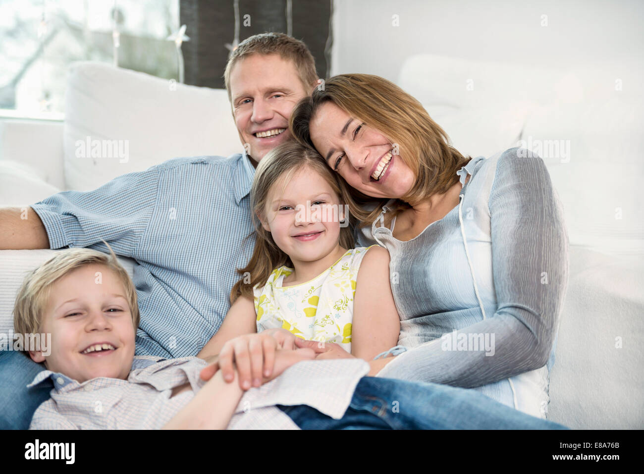 Happy family with two kids at home Stock Photo - Alamy