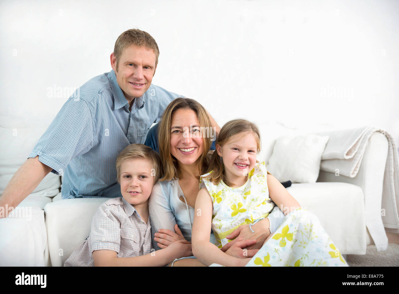 Happy family with two kids at home Stock Photo - Alamy