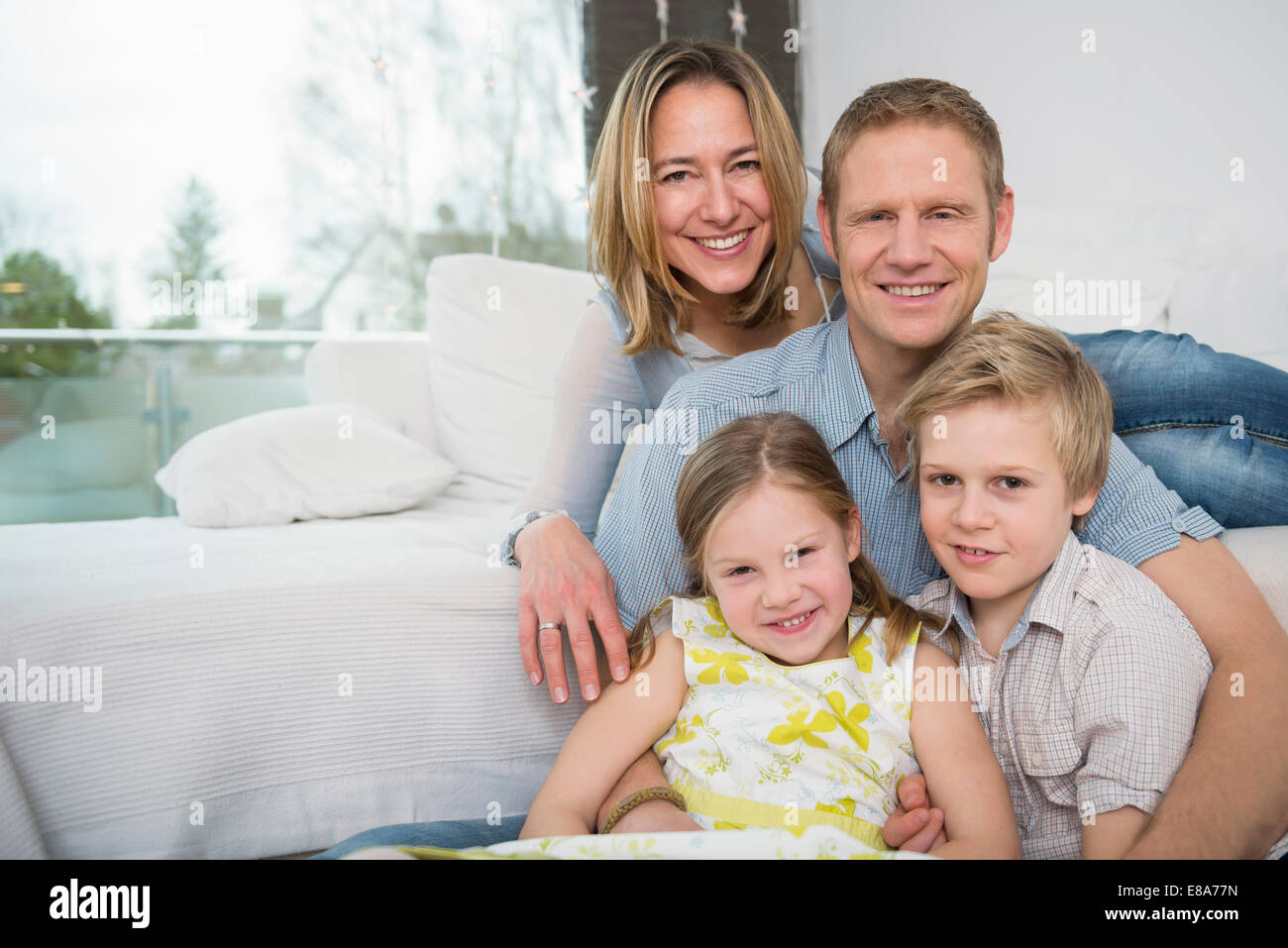 Happy family with two kids at home Stock Photo - Alamy