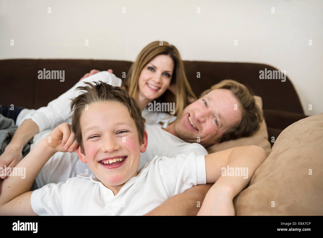 Happy family in living room Stock Photo - Alamy