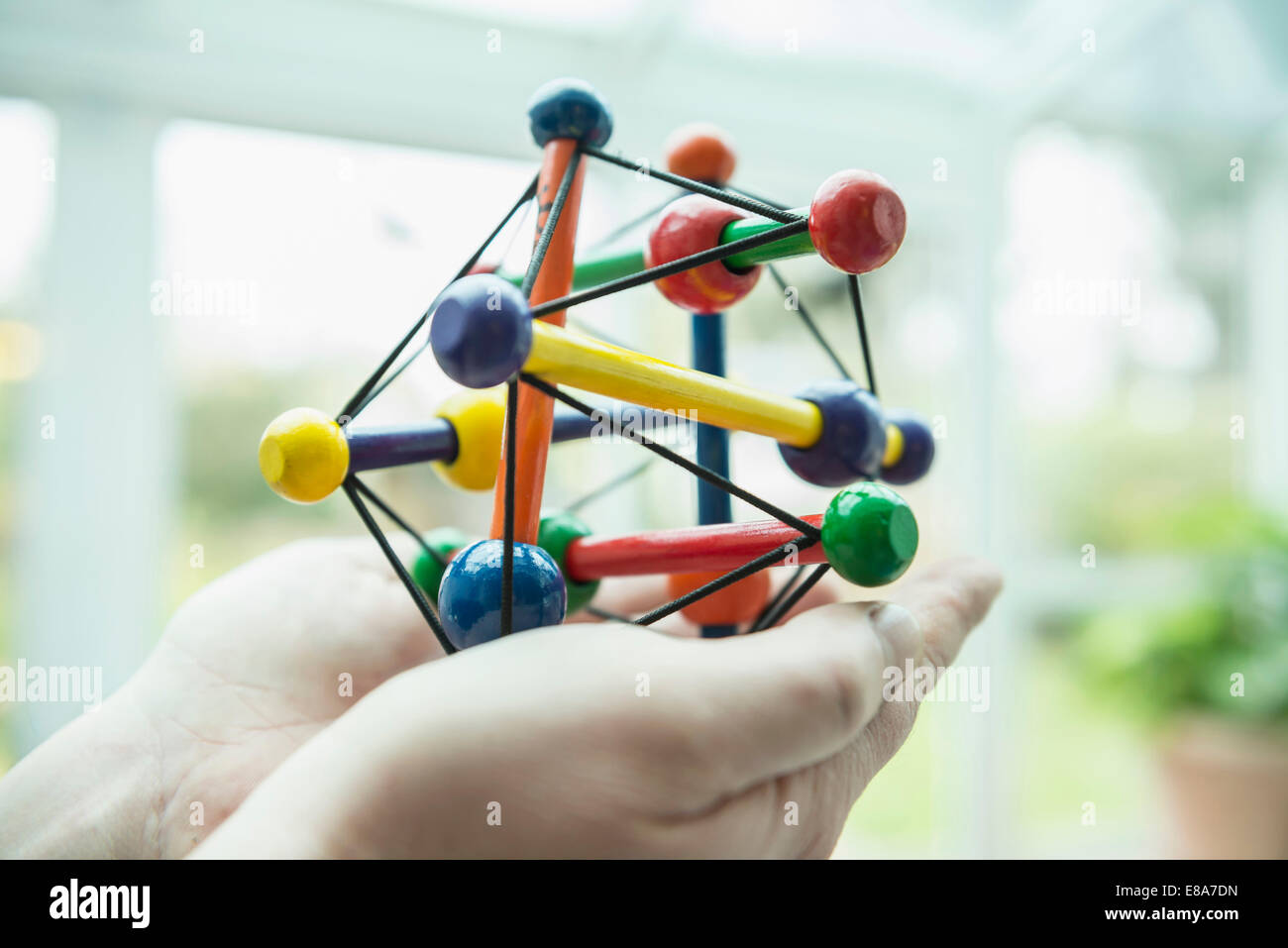 Hands holding wooden toy Stock Photo - Alamy