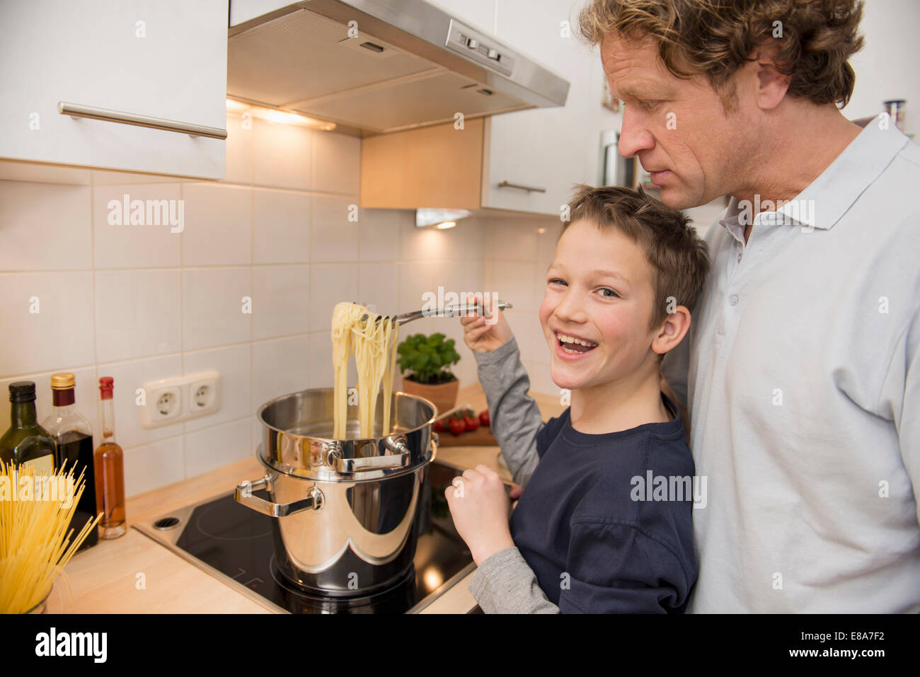 Father and son cooking spaghetti Stock Photo - Alamy