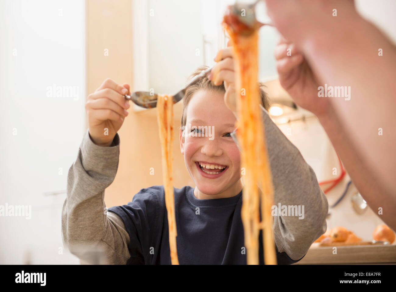 Two boys eating spaghetti hi-res stock photography and images - Alamy