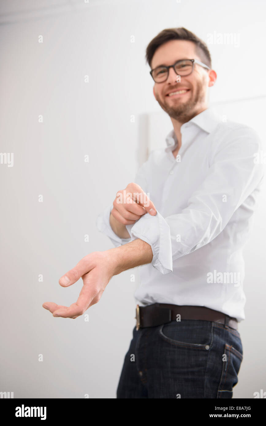 Man rolling up sleeve hi-res stock photography and images - Alamy