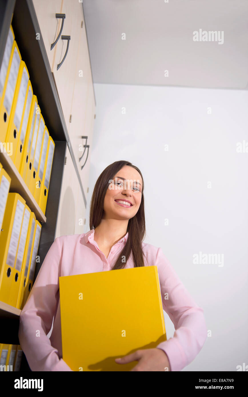 Young woman pretty working in office filing folder Stock Photo - Alamy