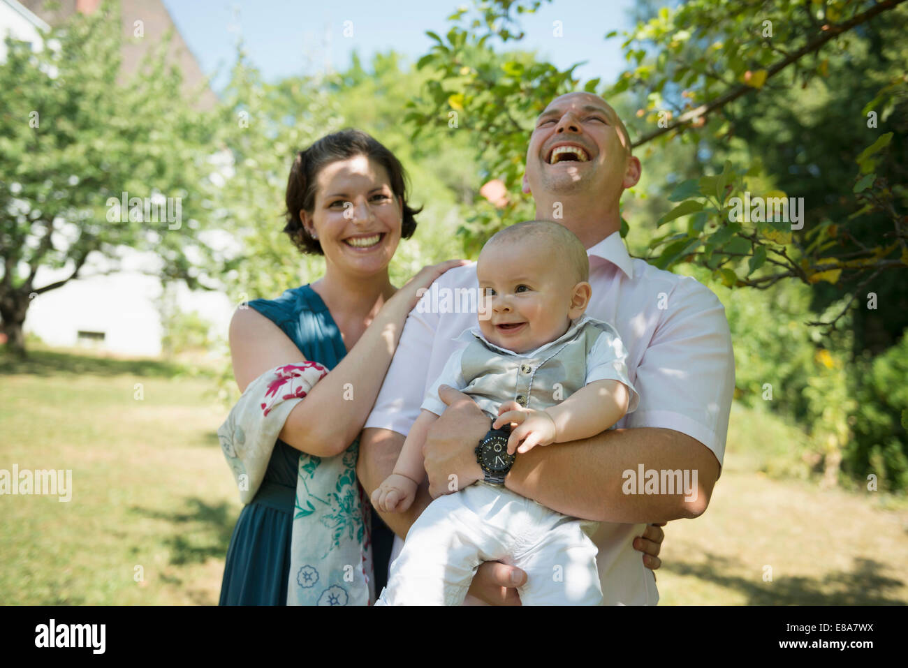 Laughing parents with smiling baby Stock Photo - Alamy