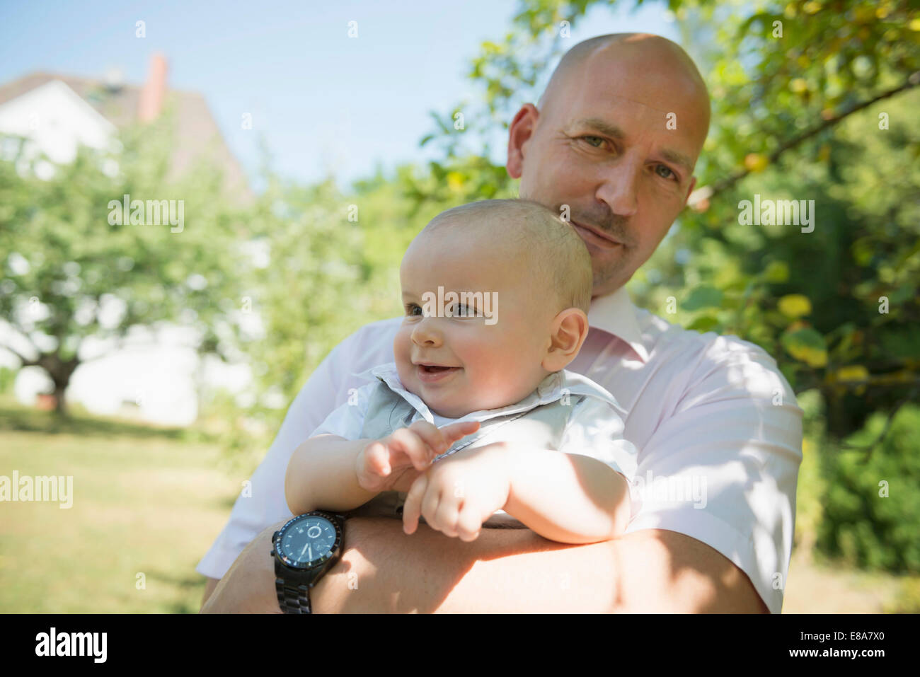 Father holding baby son proud smiling happy Stock Photo - Alamy