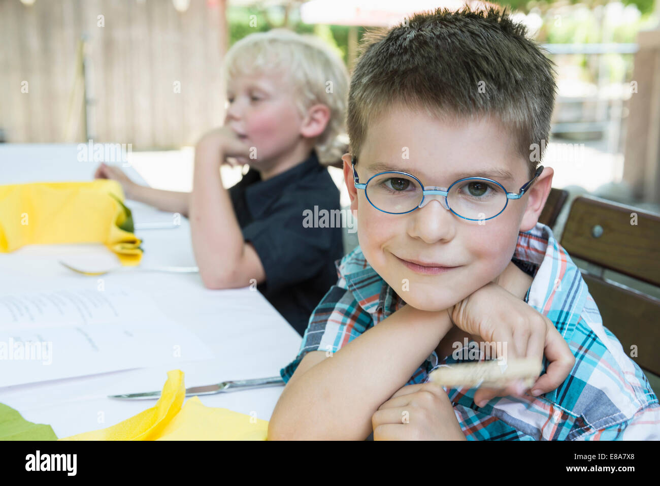 Portrait of little boy with cousin in the background Stock Photo - Alamy
