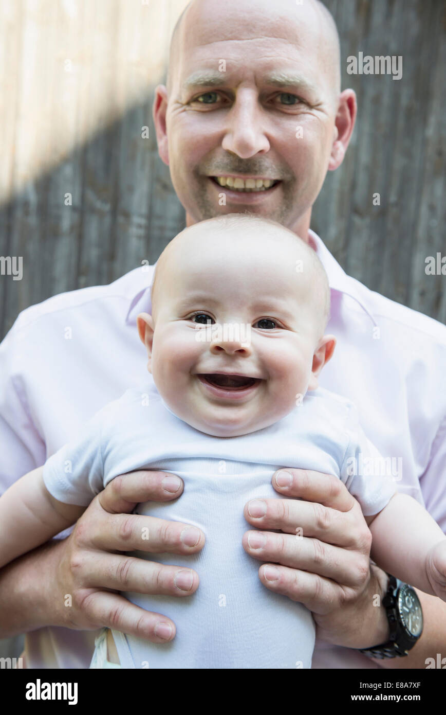 Father holding baby son proud smiling happy Stock Photo - Alamy