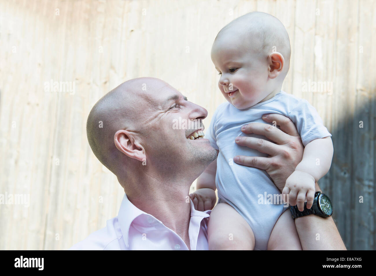 Father holding baby son proud smiling happy Stock Photo - Alamy