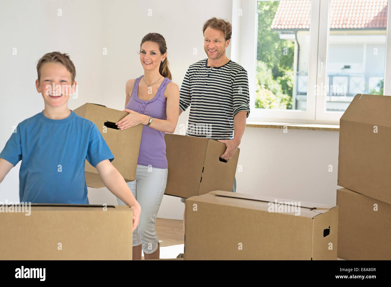 Young family father mother son moving house Stock Photo - Alamy