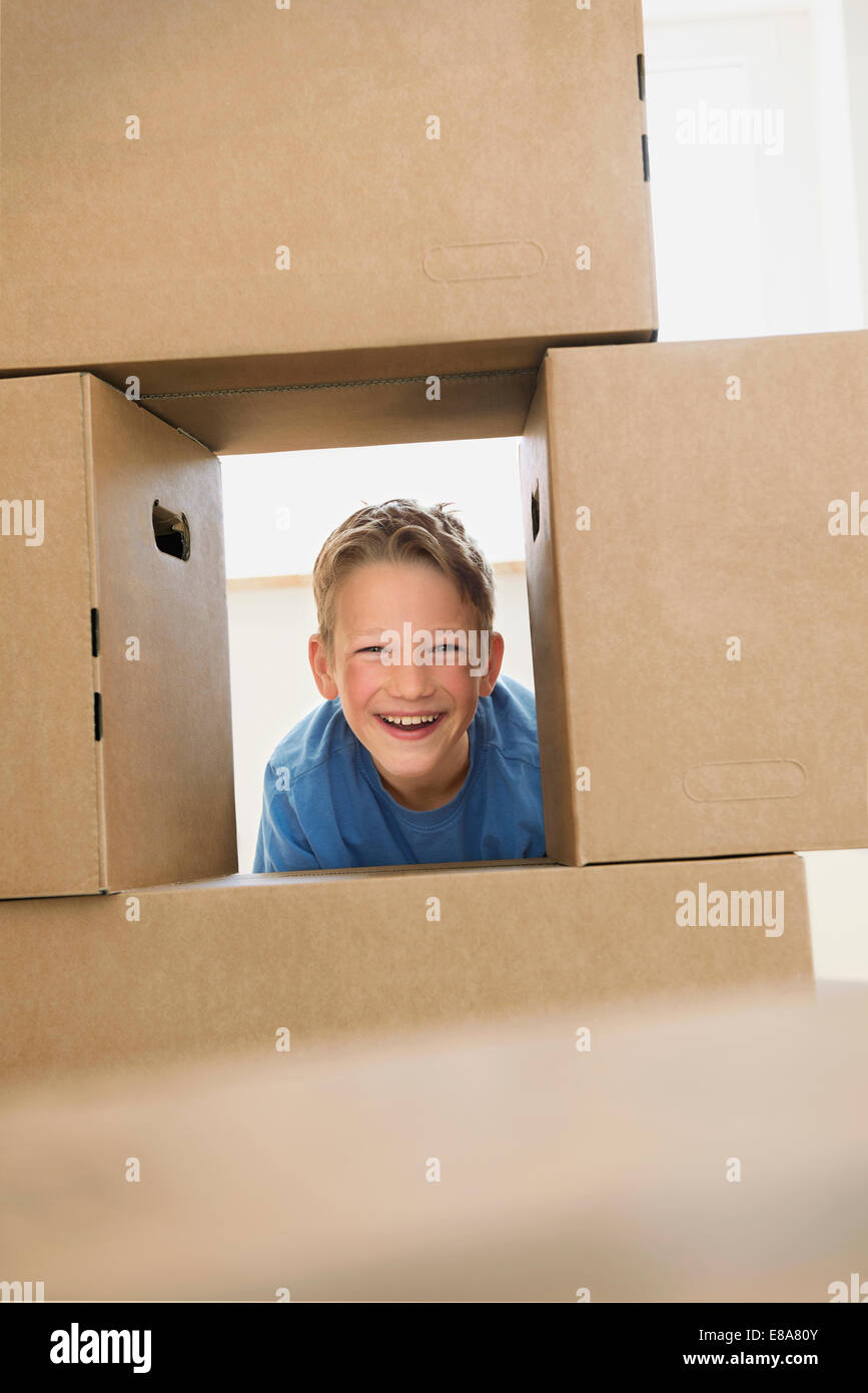 Boy building pile cardboard boxes moving house Stock Photo - Alamy