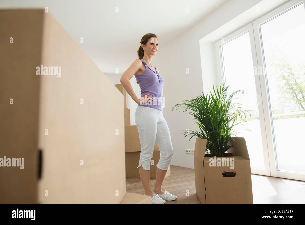 Cardboard packing cases woman decision new home Stock Photo - Alamy