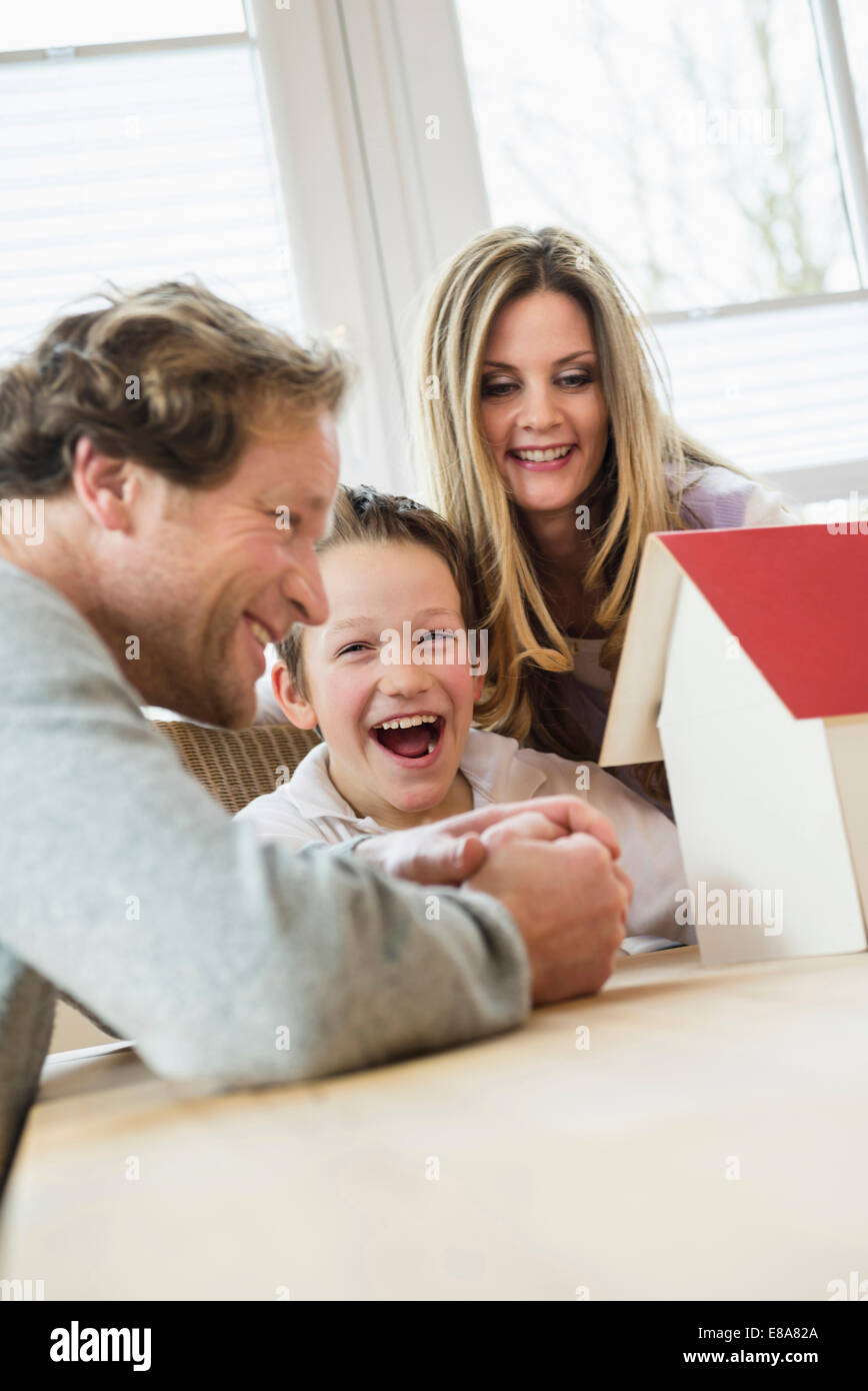 Family with architectural model at table Stock Photo - Alamy