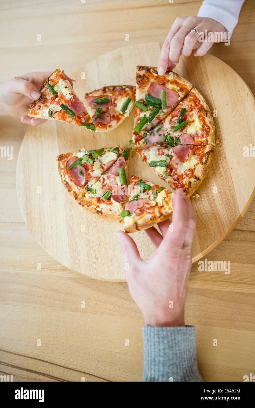 Family sharing a pizza Stock Photo - Alamy