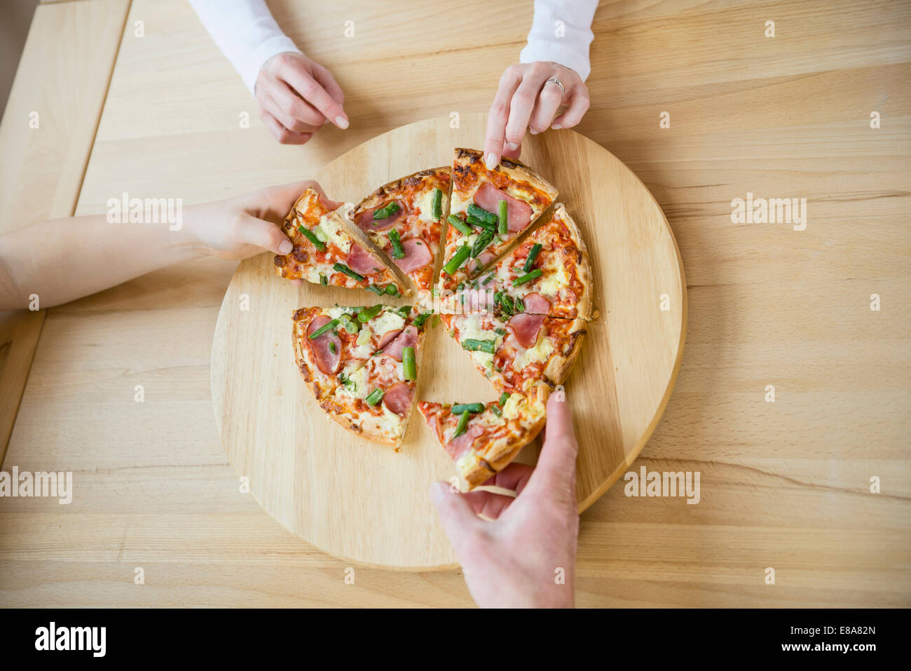 Family sharing a pizza Stock Photo - Alamy
