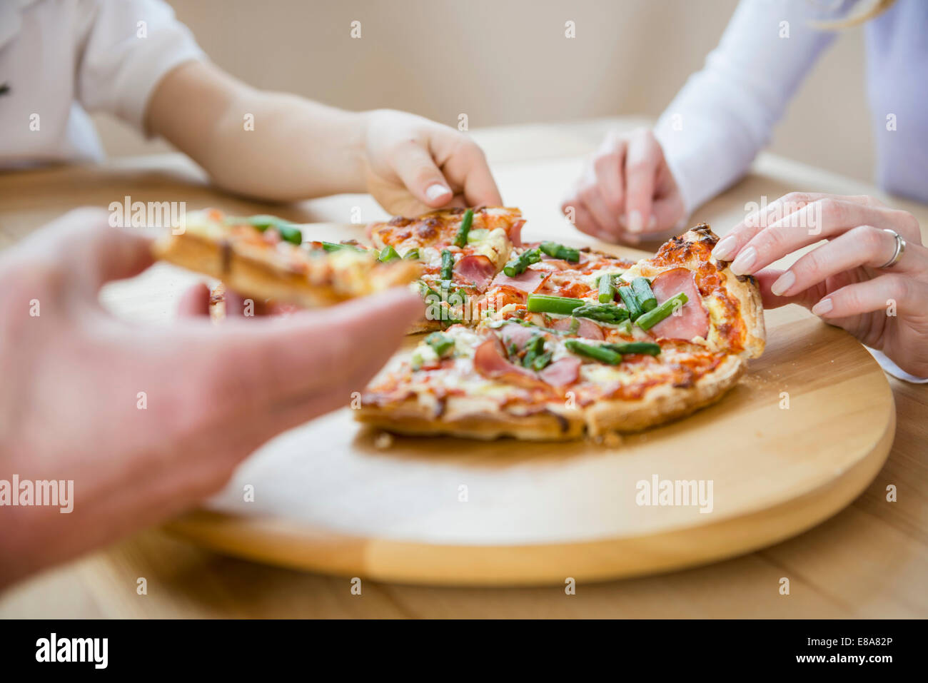 Family sharing a pizza Stock Photo - Alamy
