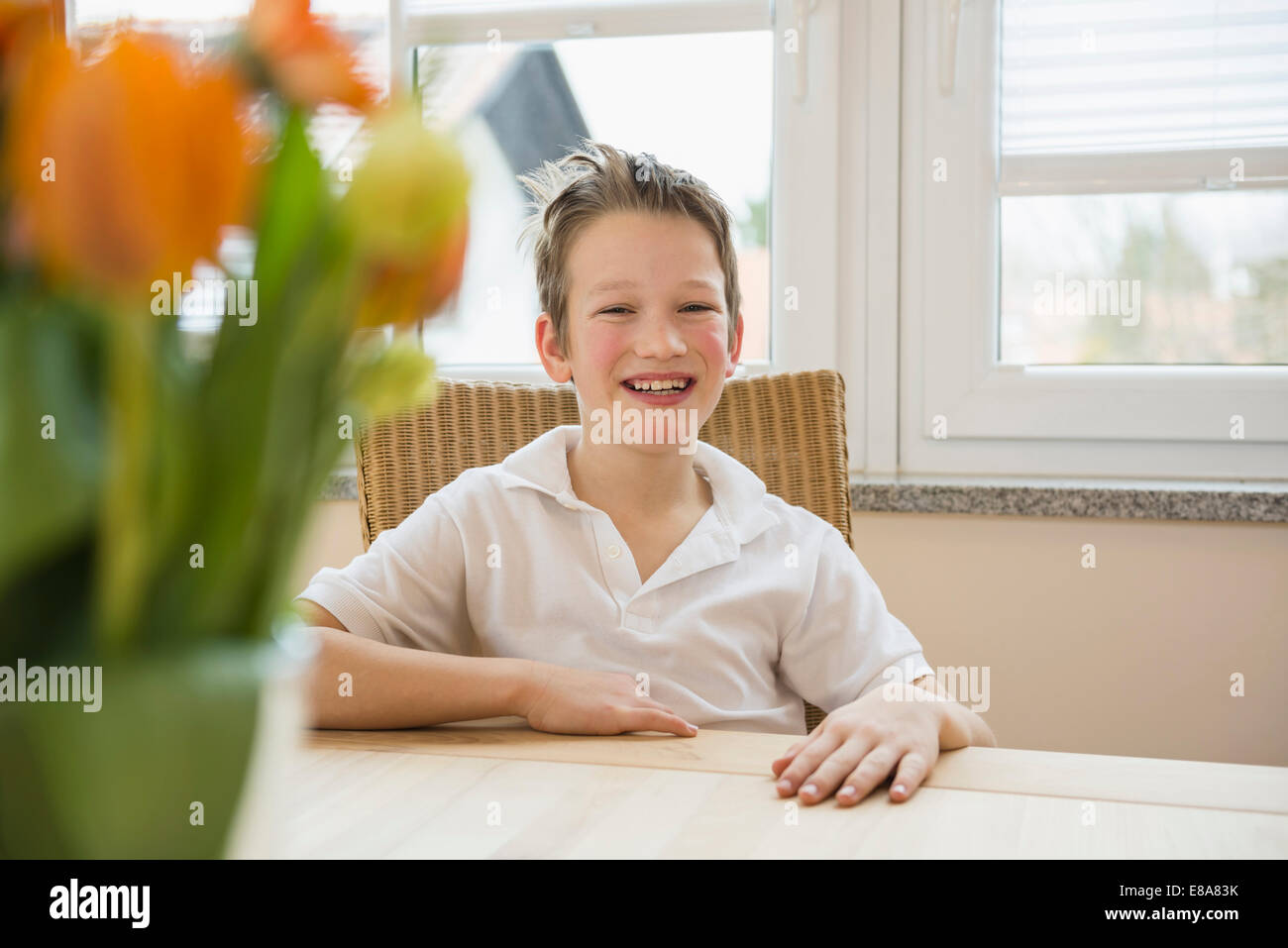 Child blond boy sitting table hi-res stock photography and images - Alamy