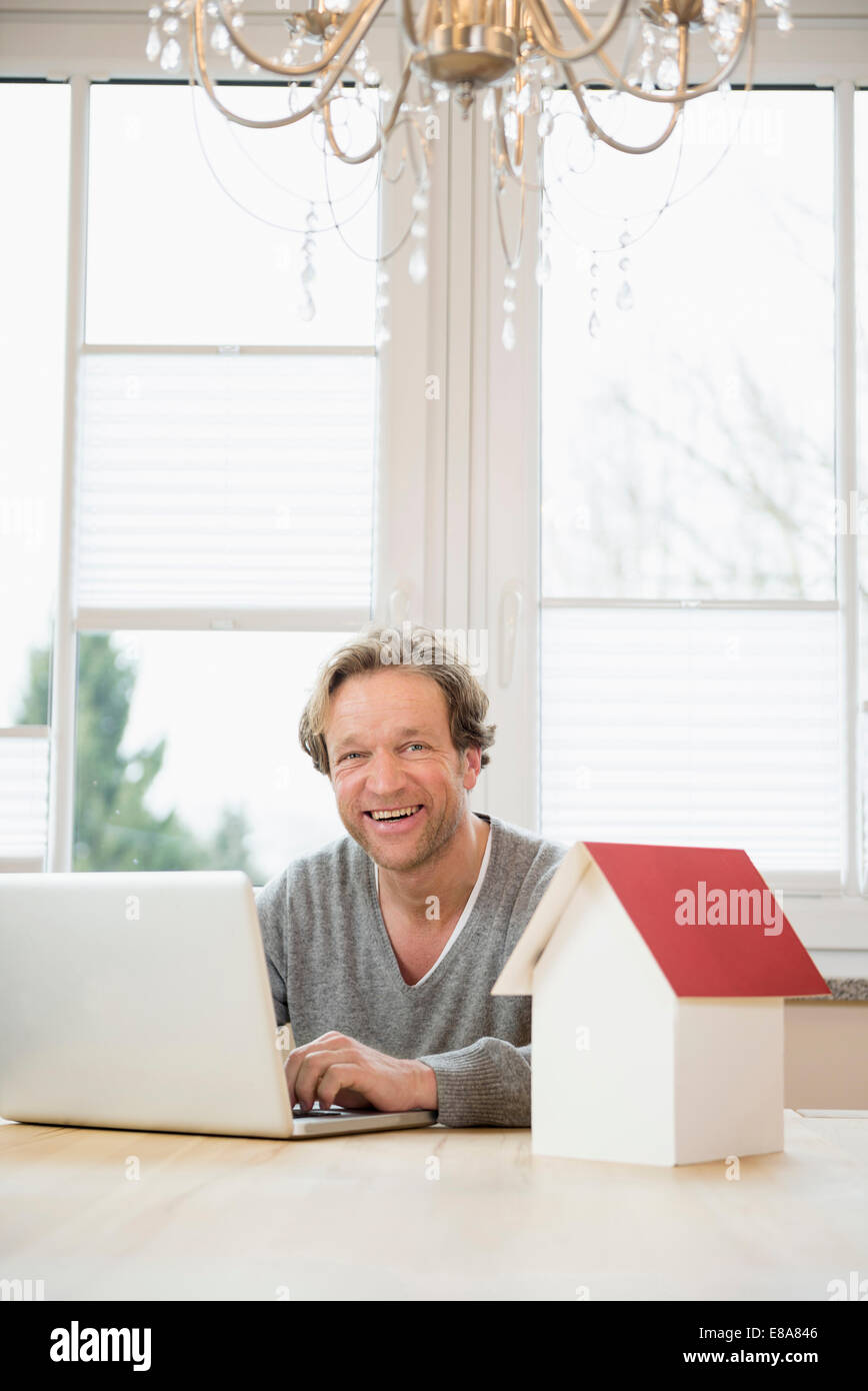 Man with architectural model and laptop at table Stock Photo - Alamy