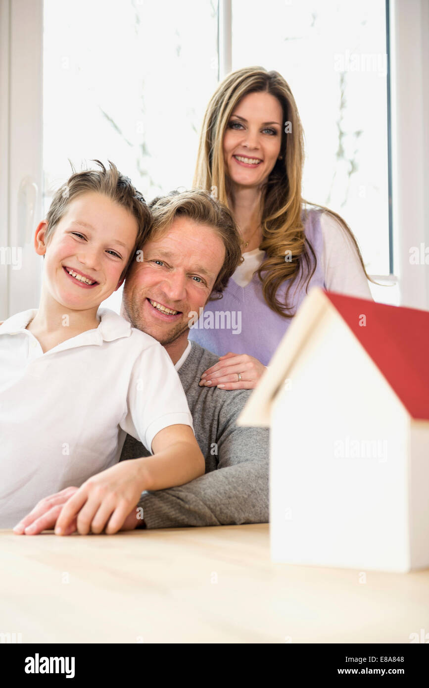 Family with architectural model at table Stock Photo - Alamy