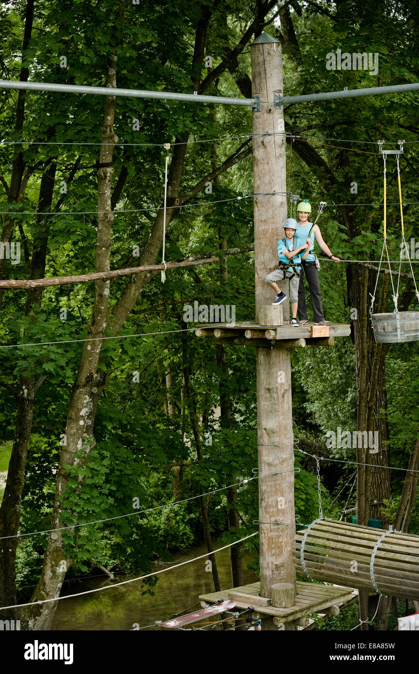 Young woman and boy climbing crag Stock Photo - Alamy