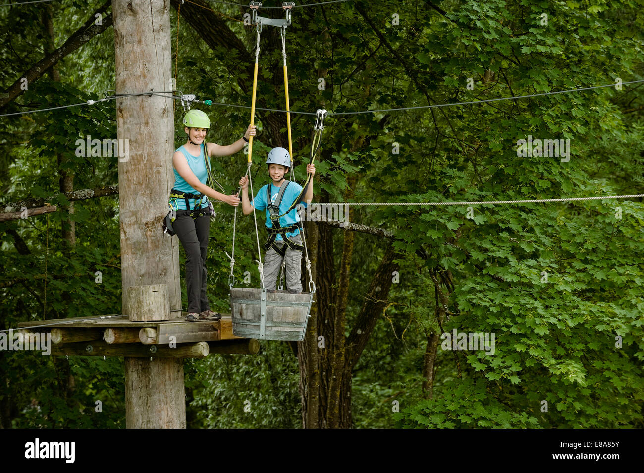 Portrait of young woman and boy climbing crag, smiling Stock Photo - Alamy